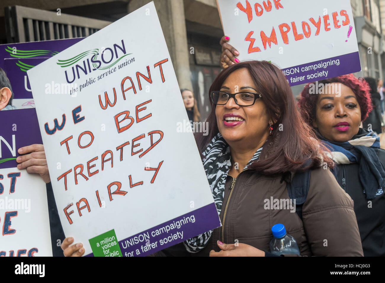 London, UK. 9th December 2016. Unison cleaners hold posters at the ...