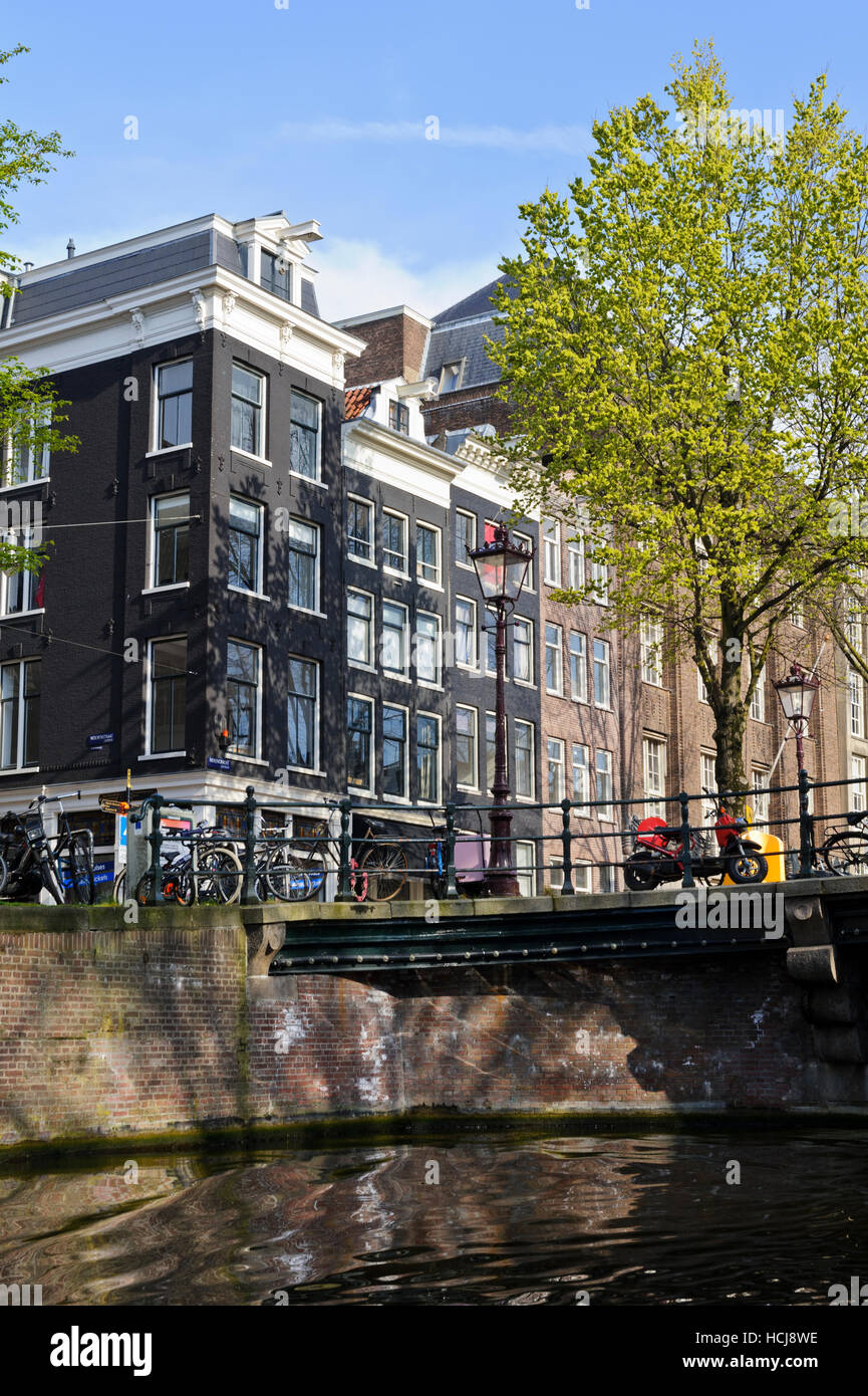 Typical buildings by the canal in the City of Amsterdam, Holland ...
