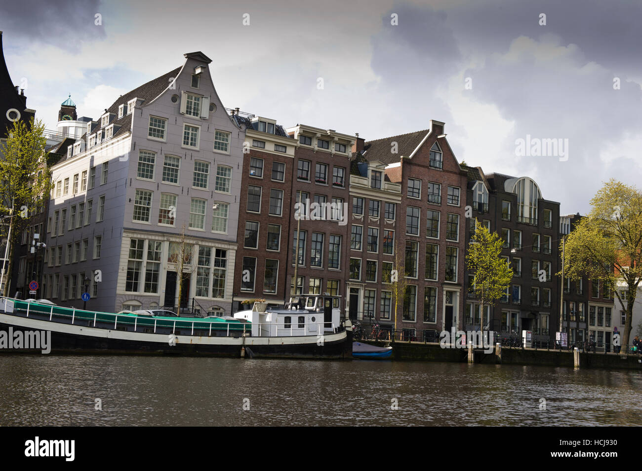 Traditional buildings by the canal in the City of Amsterdam, Holland ...