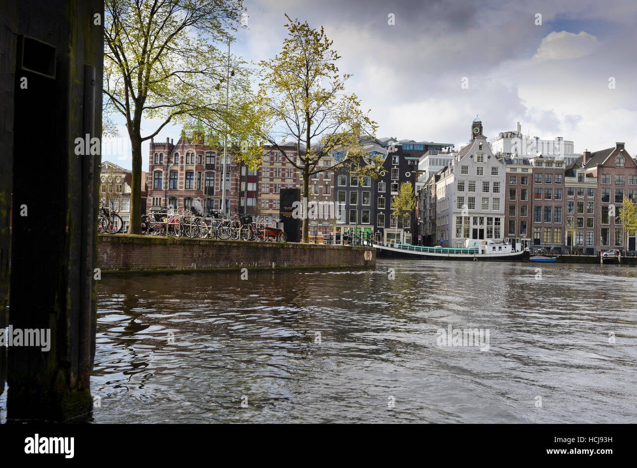 Traditional buildings by the canal in the City of Amsterdam, Holland ...