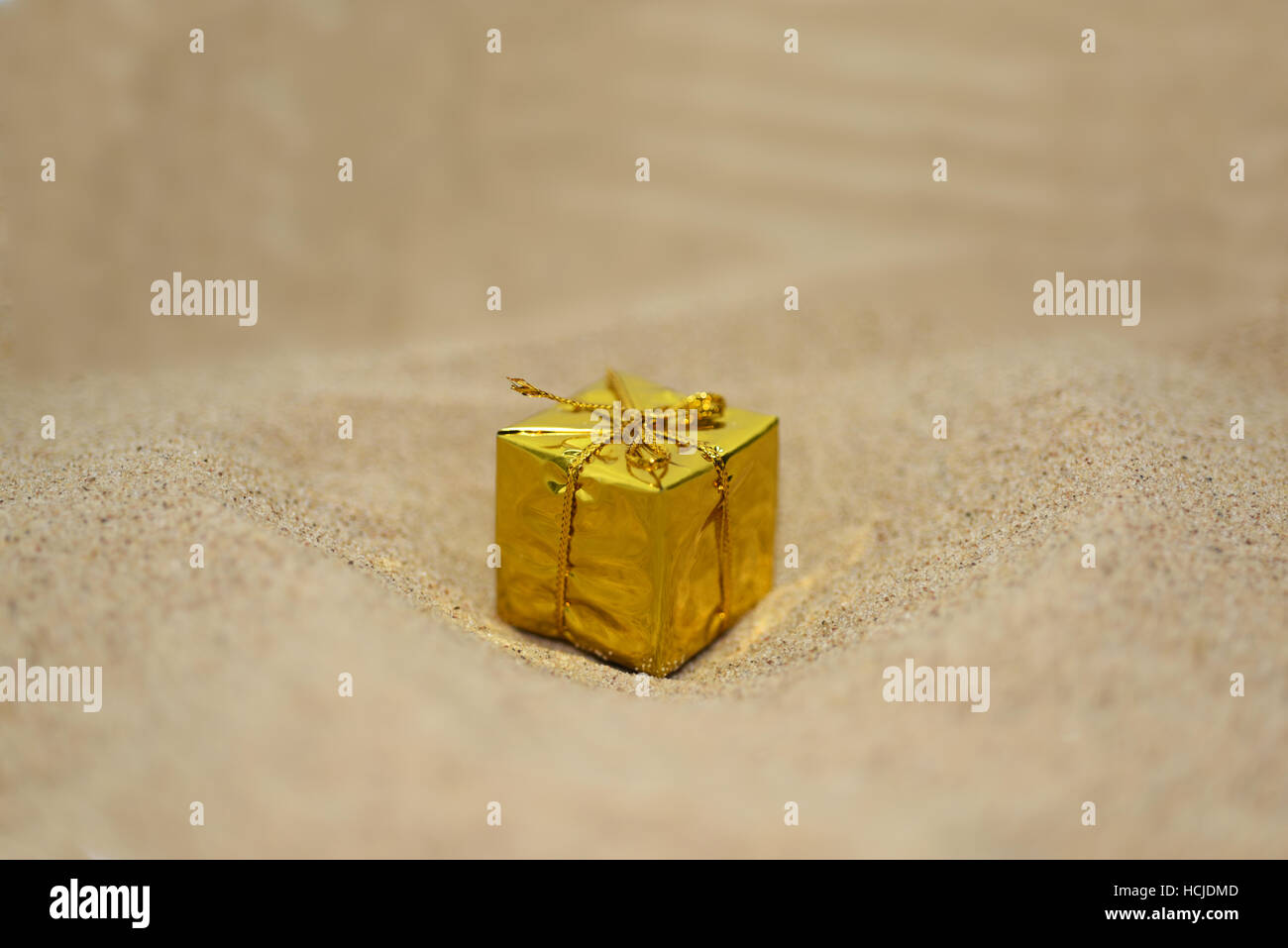Golden small present Stock Photo - Alamy