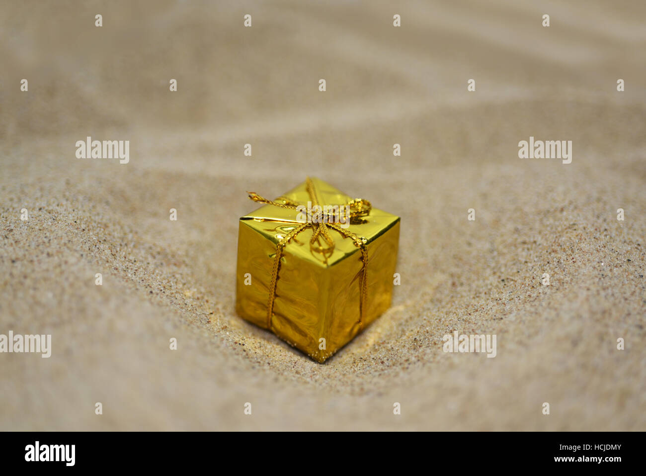 Golden small present Stock Photo - Alamy