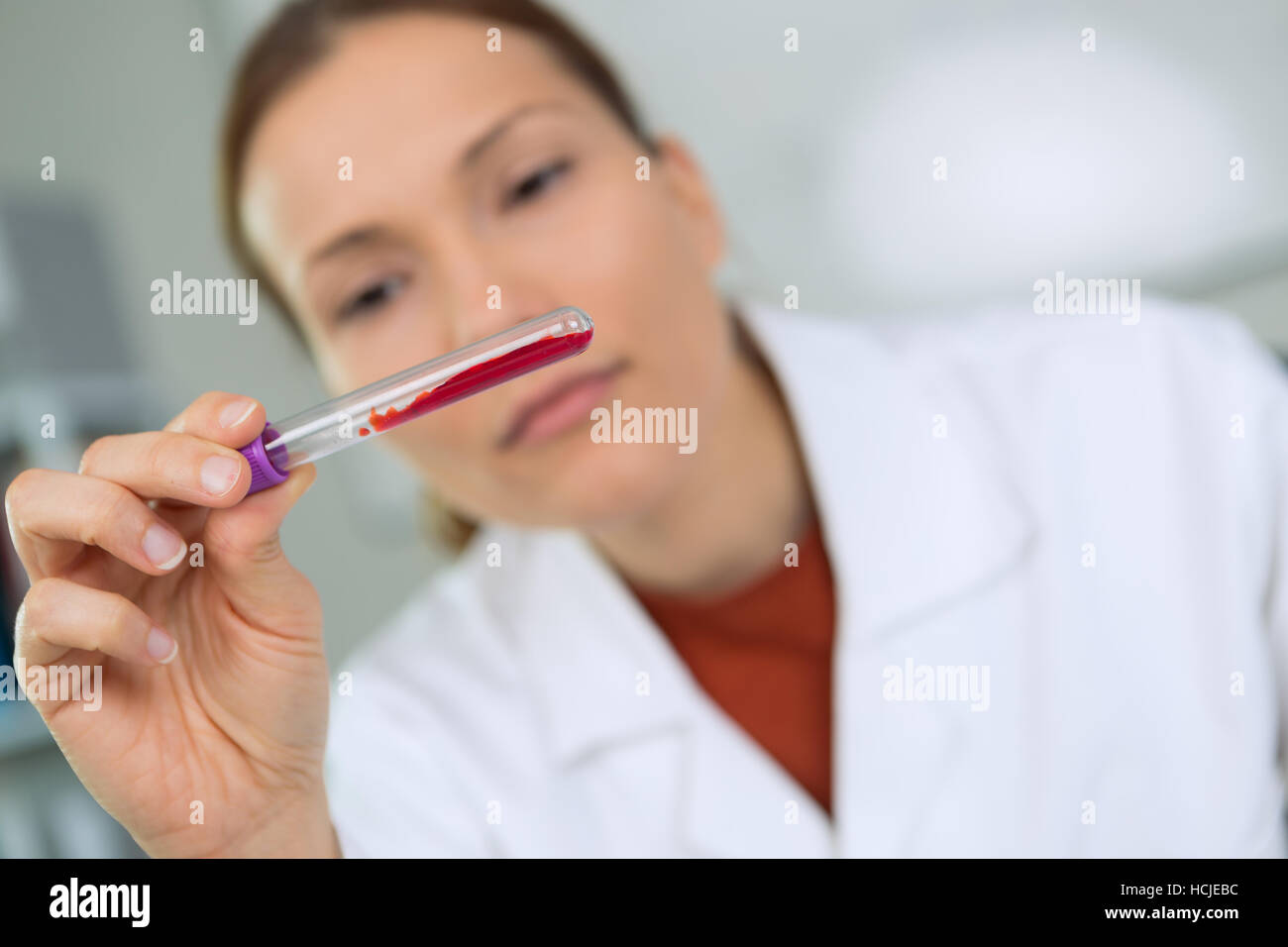 female lab worker holding test-tube Stock Photo - Alamy