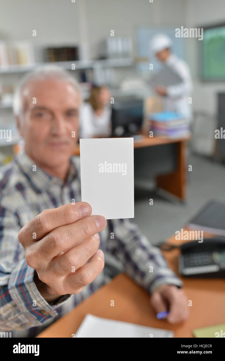 man holding card in office Stock Photo - Alamy