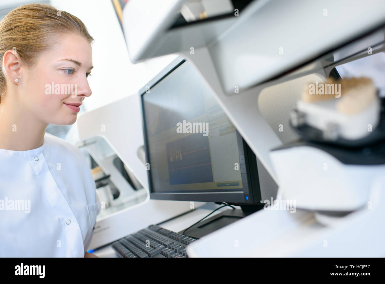 Female dentist sat at her computer Stock Photo - Alamy
