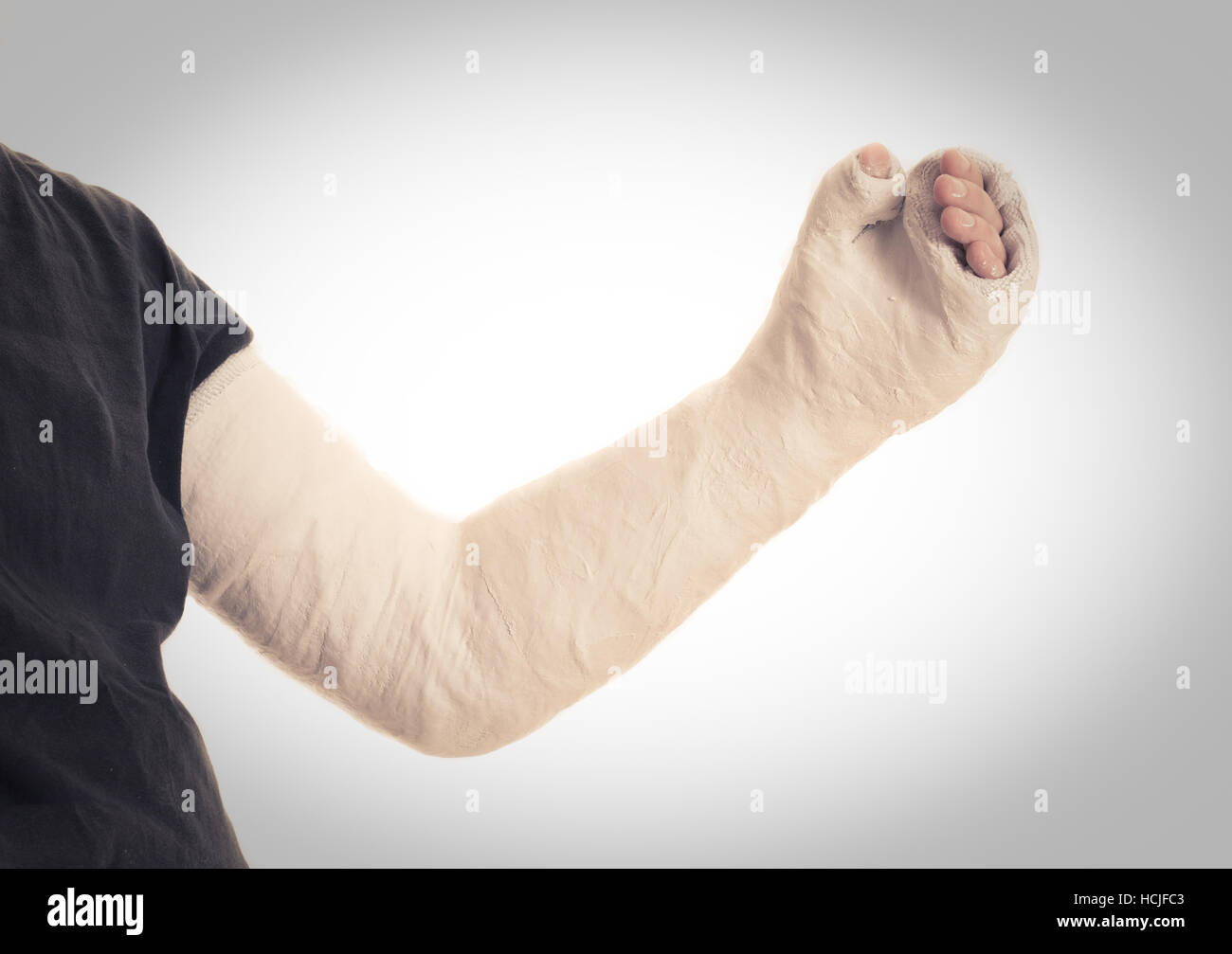 Close up of a young man's white long arm plaster / fiberglass cast ...