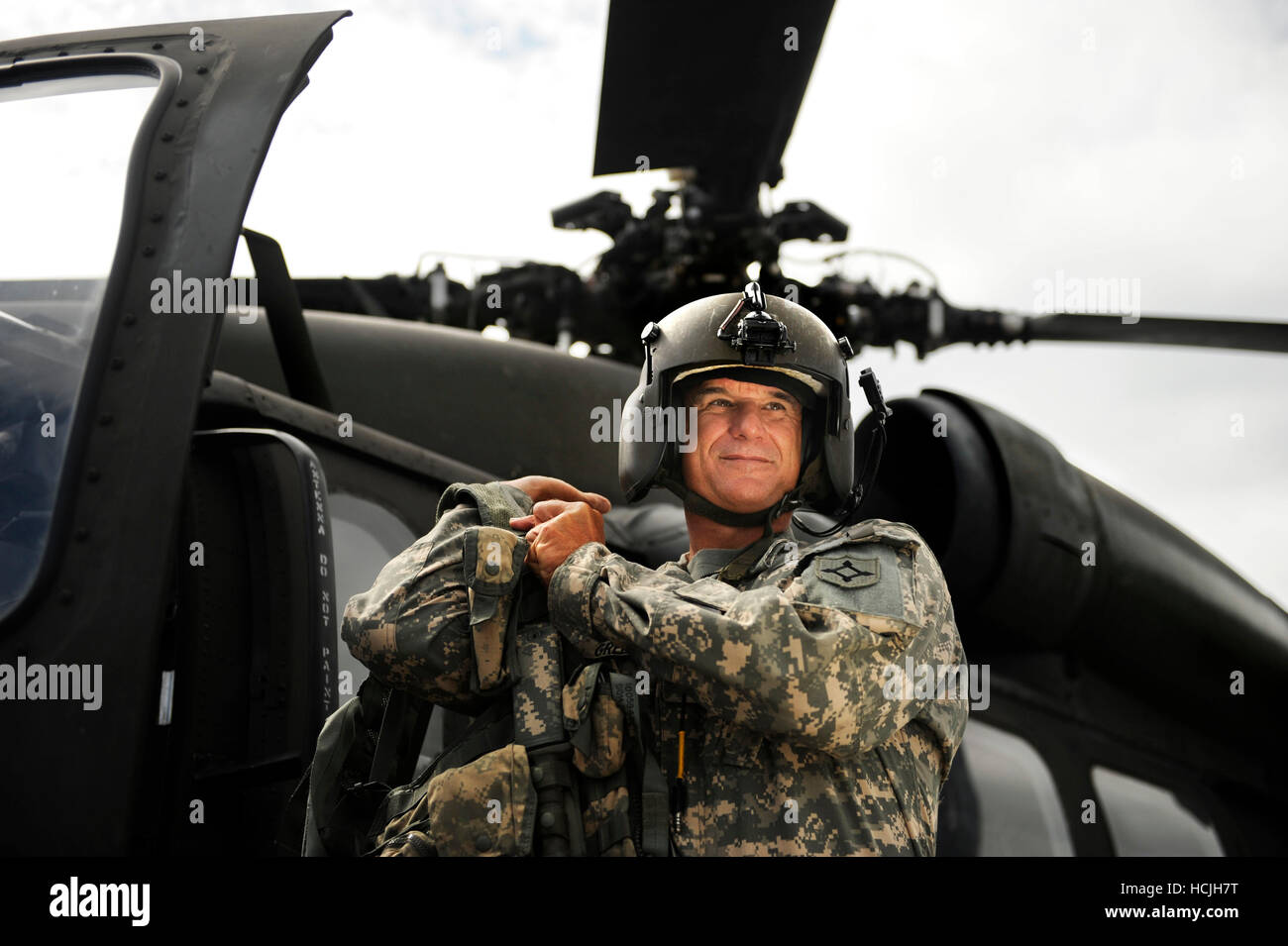 A soldier wearing his flight helmet gets ready for a routine helicopter ...
