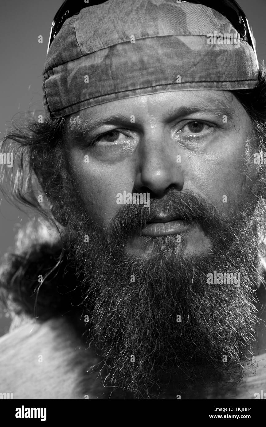 A male veteran with a full beard and mustache poses for a portrait ...