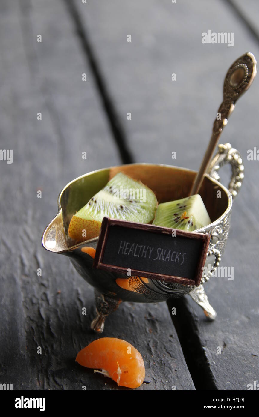 Healthy snacks tag and fruits on table. Food background Stock Photo - Alamy