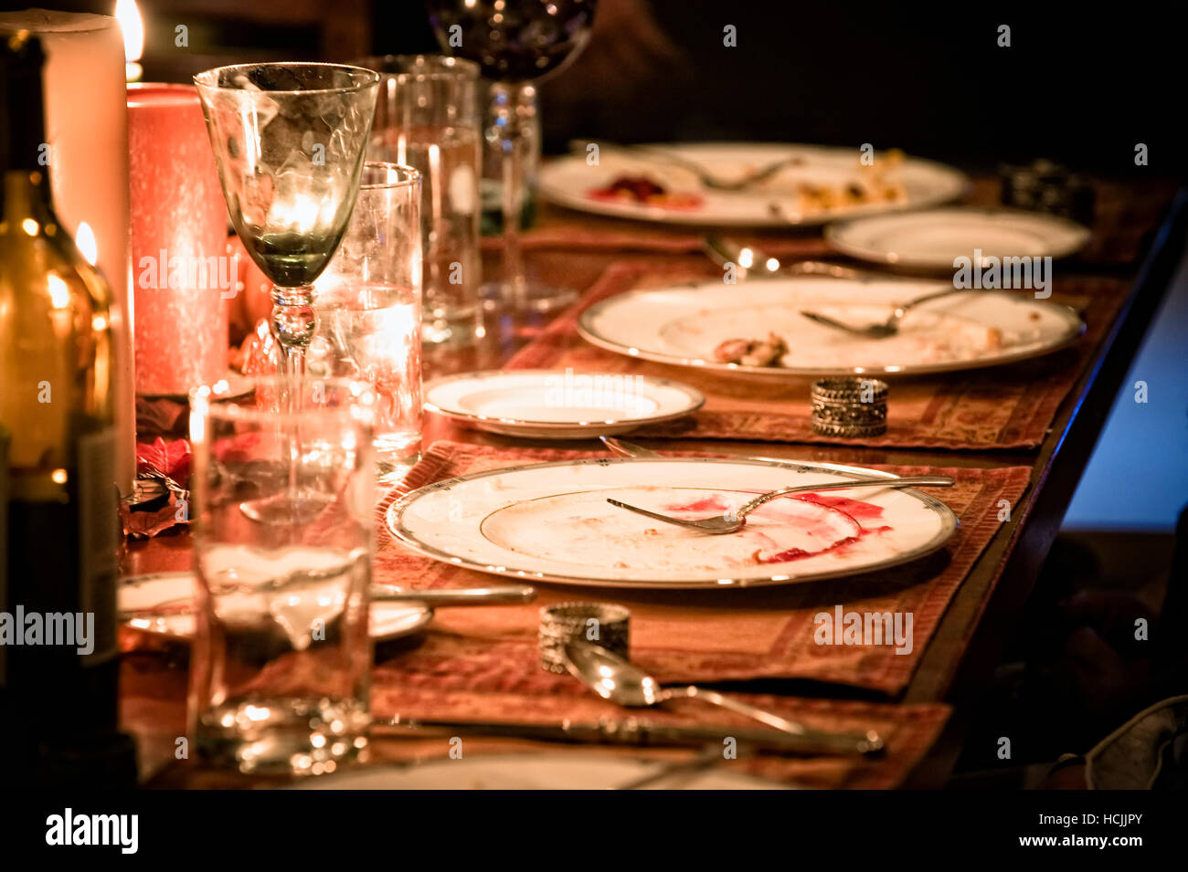 Empty plates and glasses after a Thanksgiving holiday family dinner ...