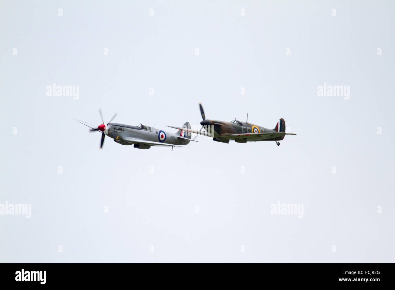 Two versions of the Spitfire aeroplane flying alongside each other at ...