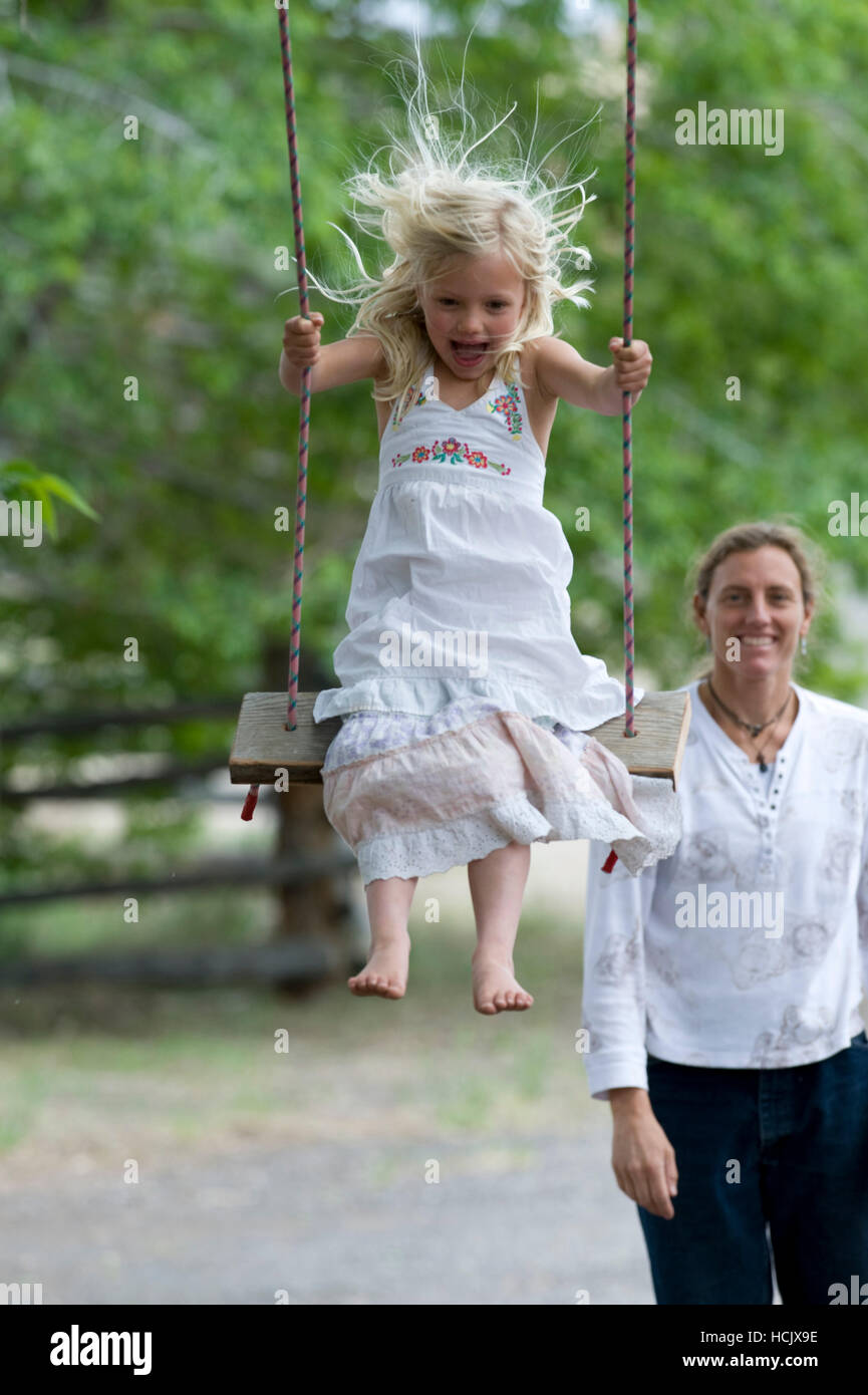Blonde, barefoot little girl wearing a summer dress gets pushed by her ... Blonde, barefoot little girl wearing a summer dress gets pushed by her ...