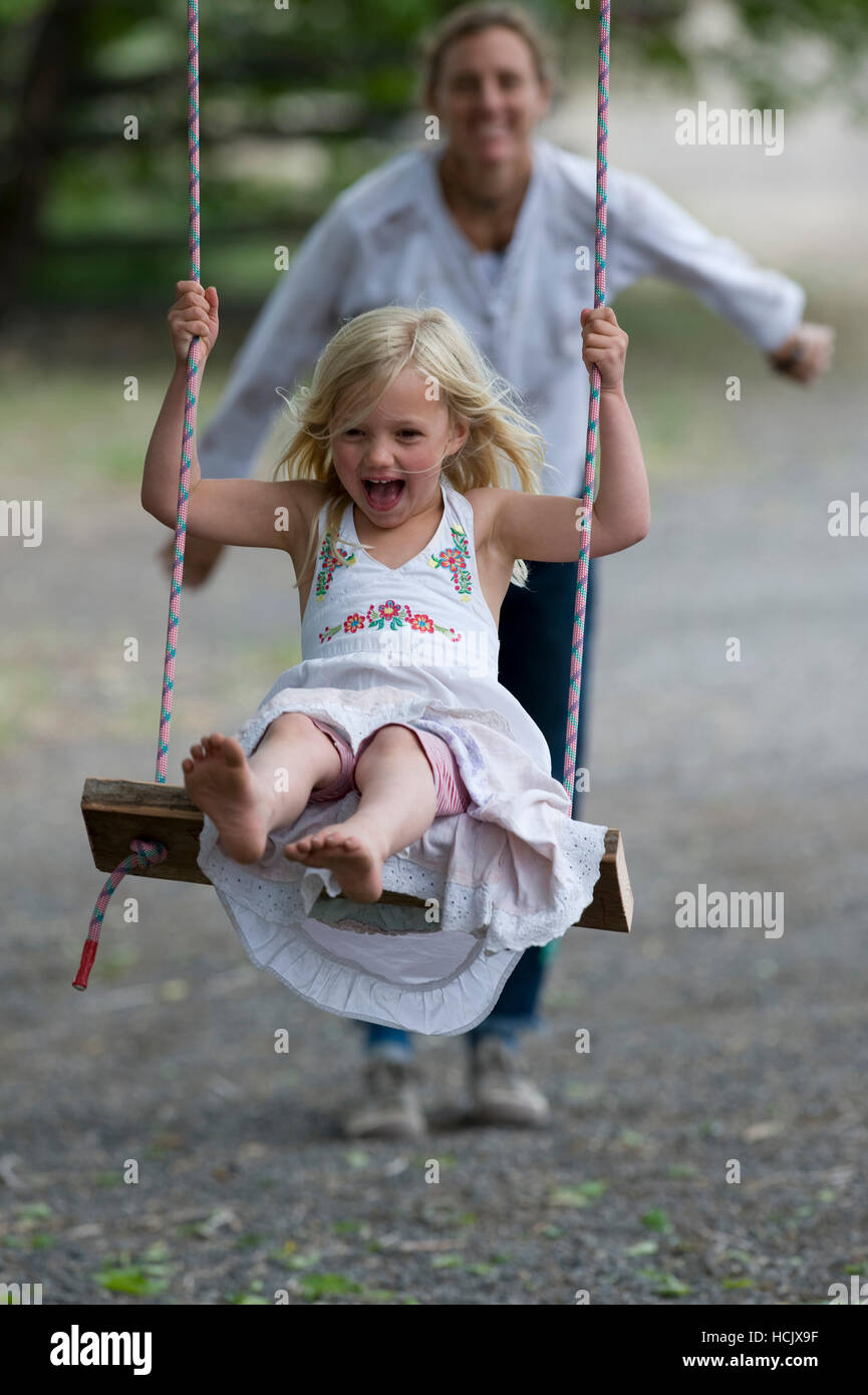 Blonde, barefoot little girl wearing a summer dress gets pushed by her ... Blonde, barefoot little girl wearing a summer dress gets pushed by her ...