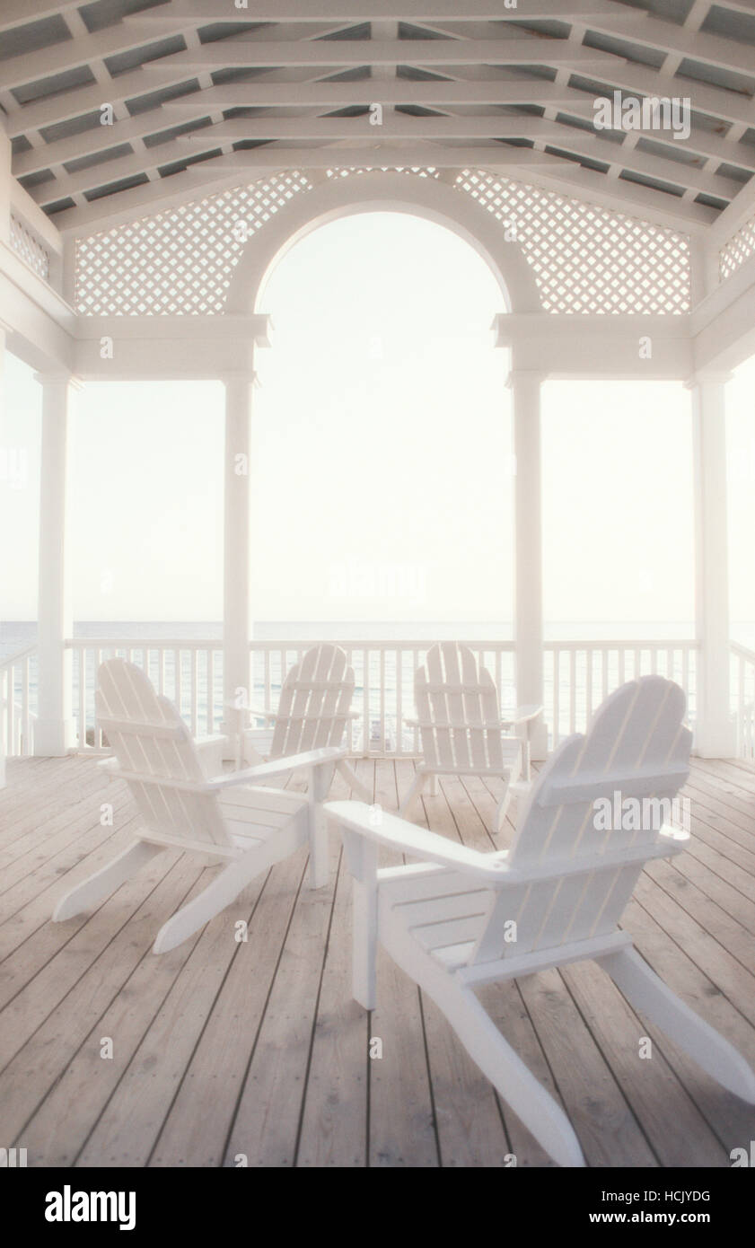 White Adirondack chairs over look the Gulf of Mexico inside a classic ...