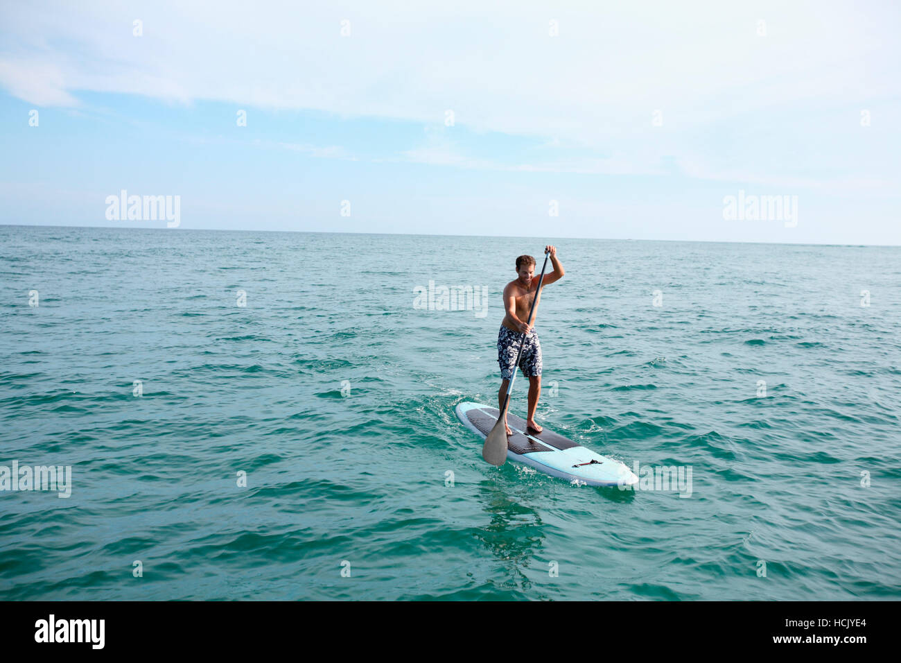A man Stand-Up paddleboards in the open ocean off Wrightsville Beach ...