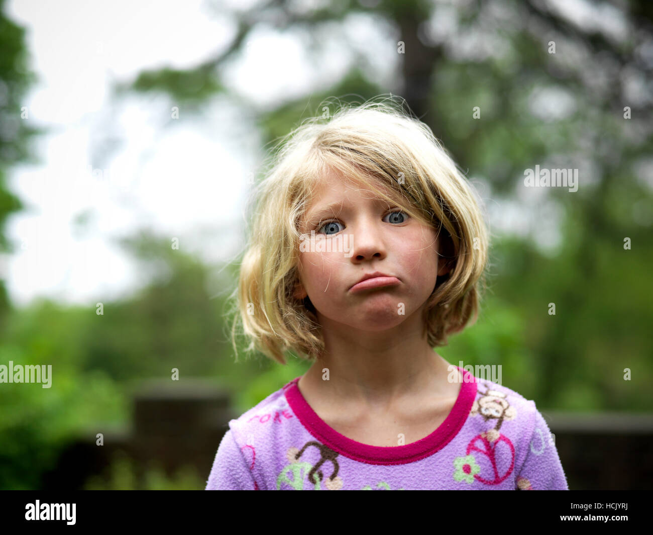 Young girl makes funny face Stock Photo - Alamy