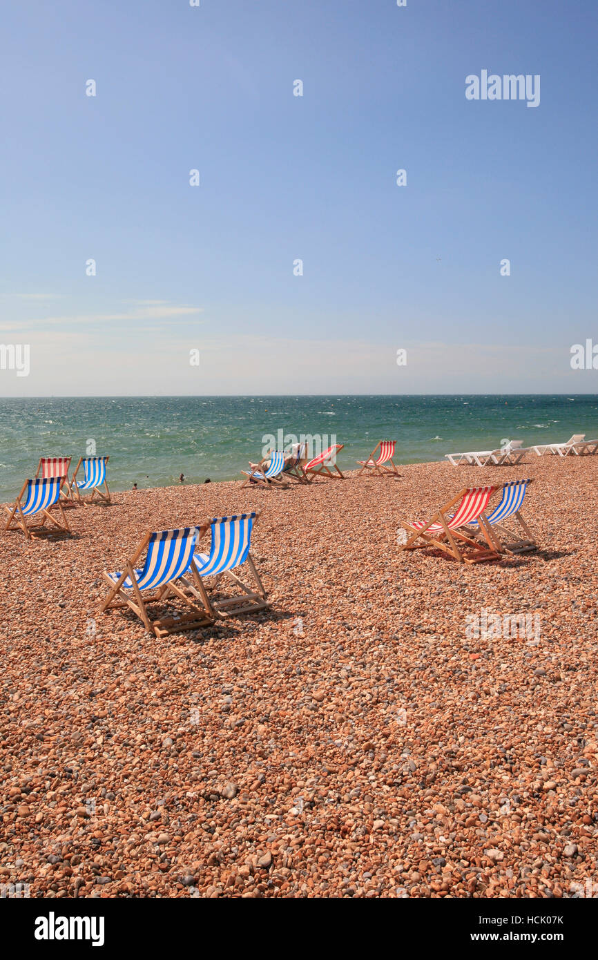 Deckchairs and sun loungers line the stone beach at Brighton on England ...