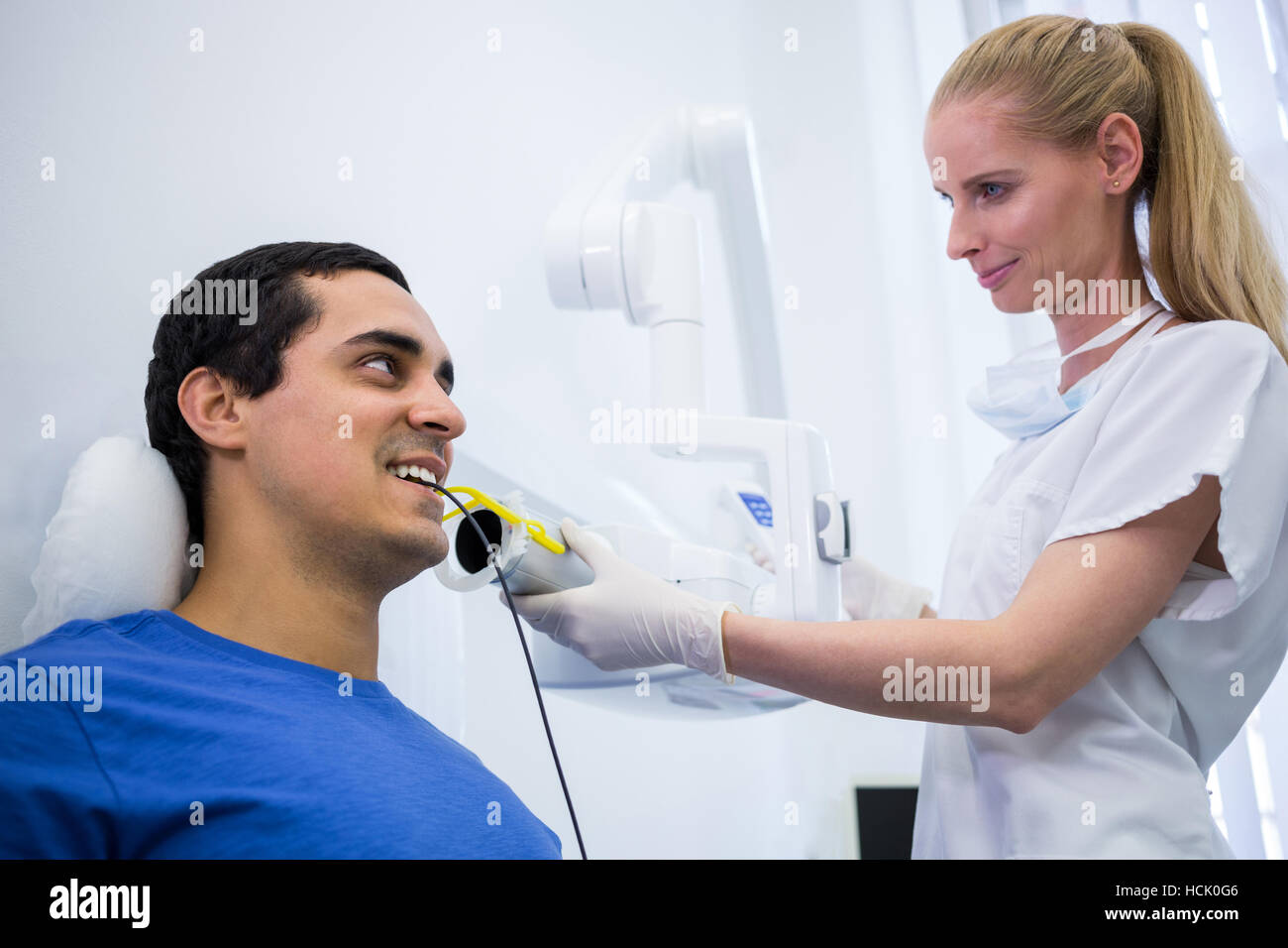 Dentist taking a male patients tooth x-ray Stock Photo - Alamy