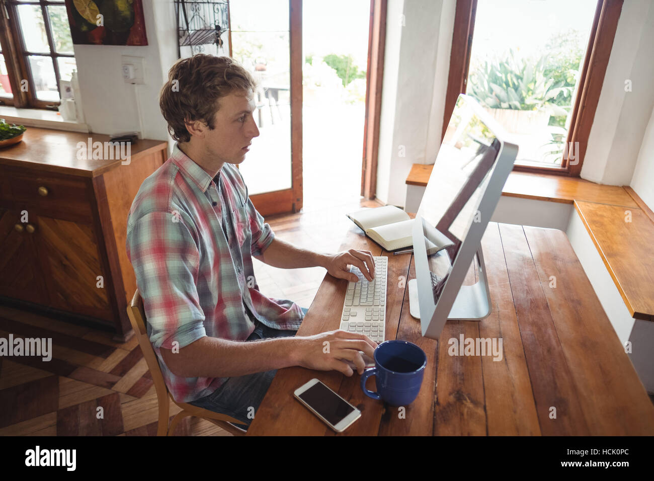 Man sitting at computer hi-res stock photography and images - Alamy