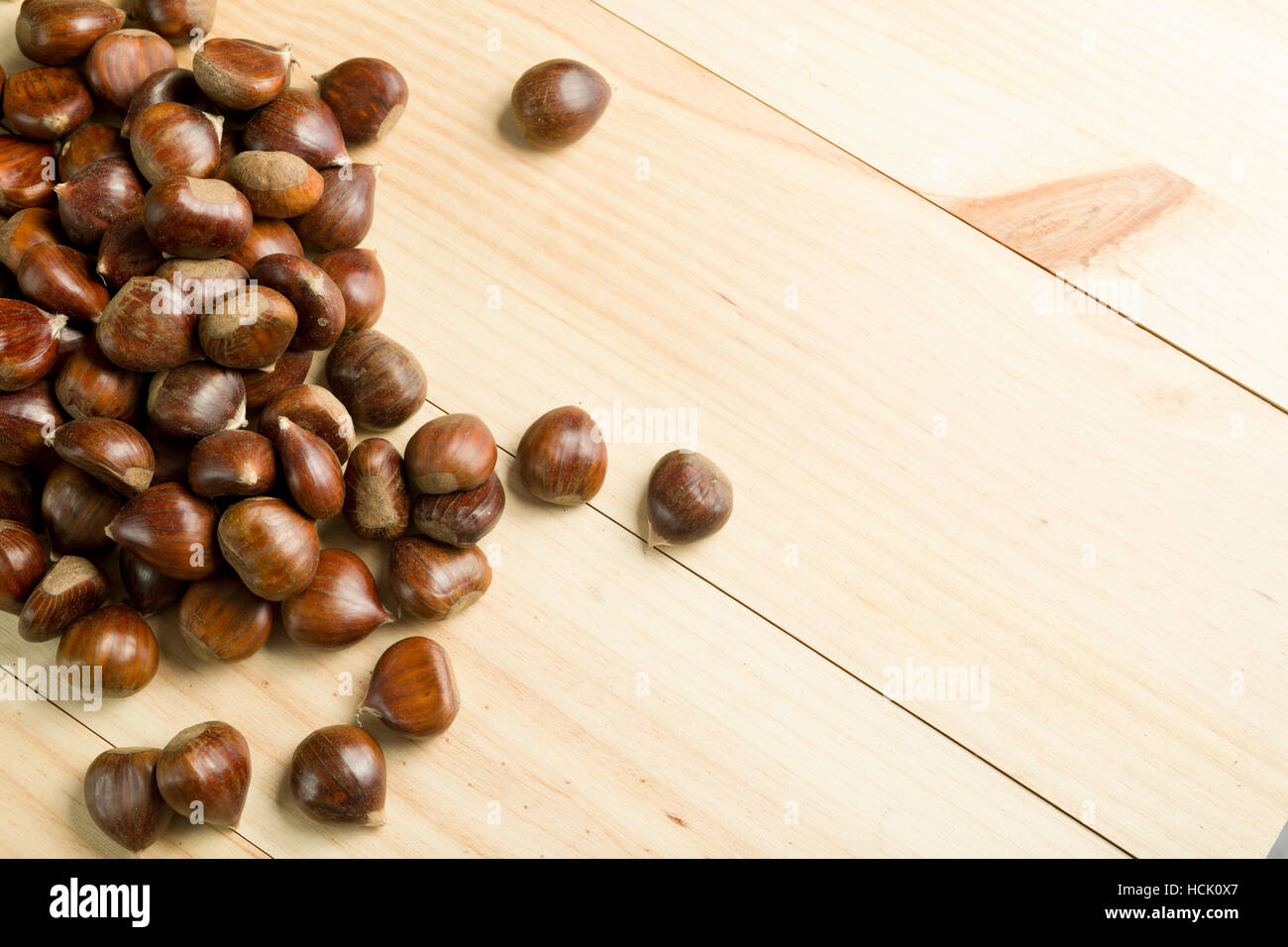 Chestnuts on pine wood background, illuminated with studio flax artificial light Stock Photo - Alamy