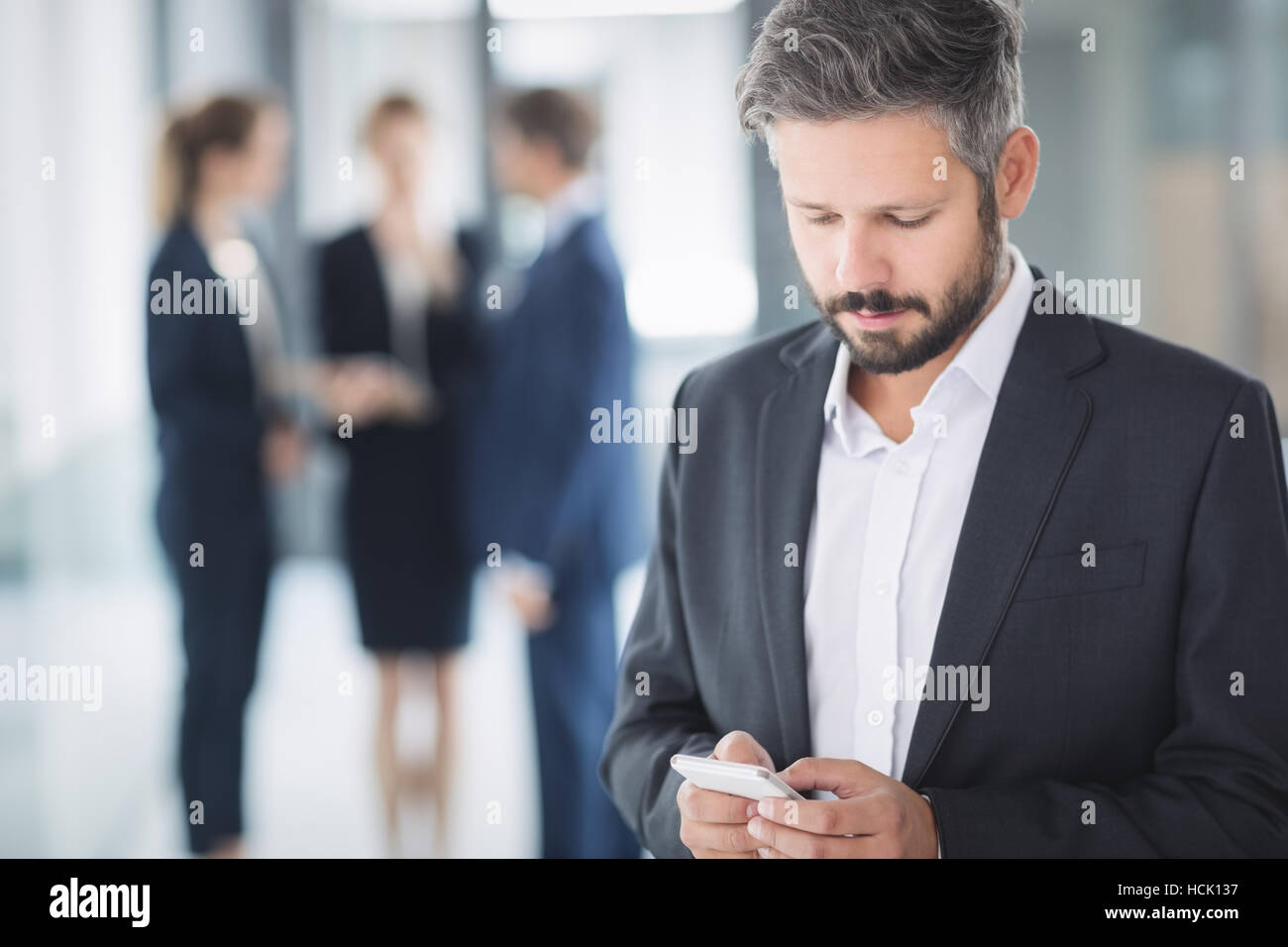 Businessman using mobile phone Stock Photo - Alamy