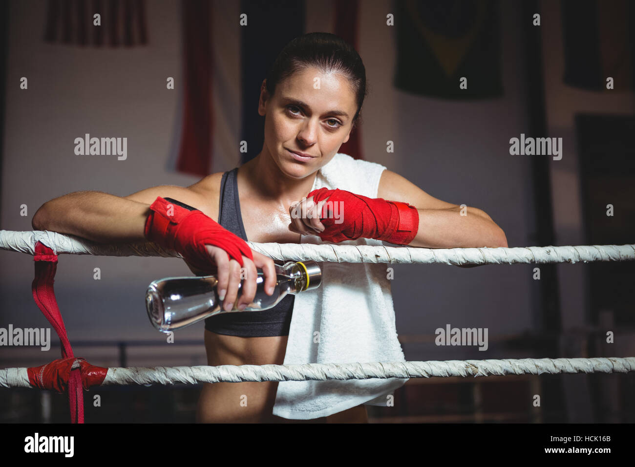 Female boxer holding water bottle in boxing ring Stock Photo - Alamy
