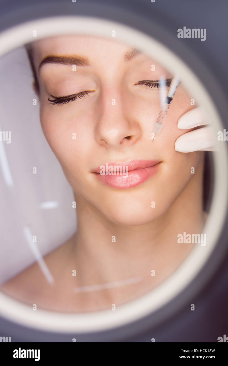 Female patient receiving an injection on her face Stock Photo - Alamy