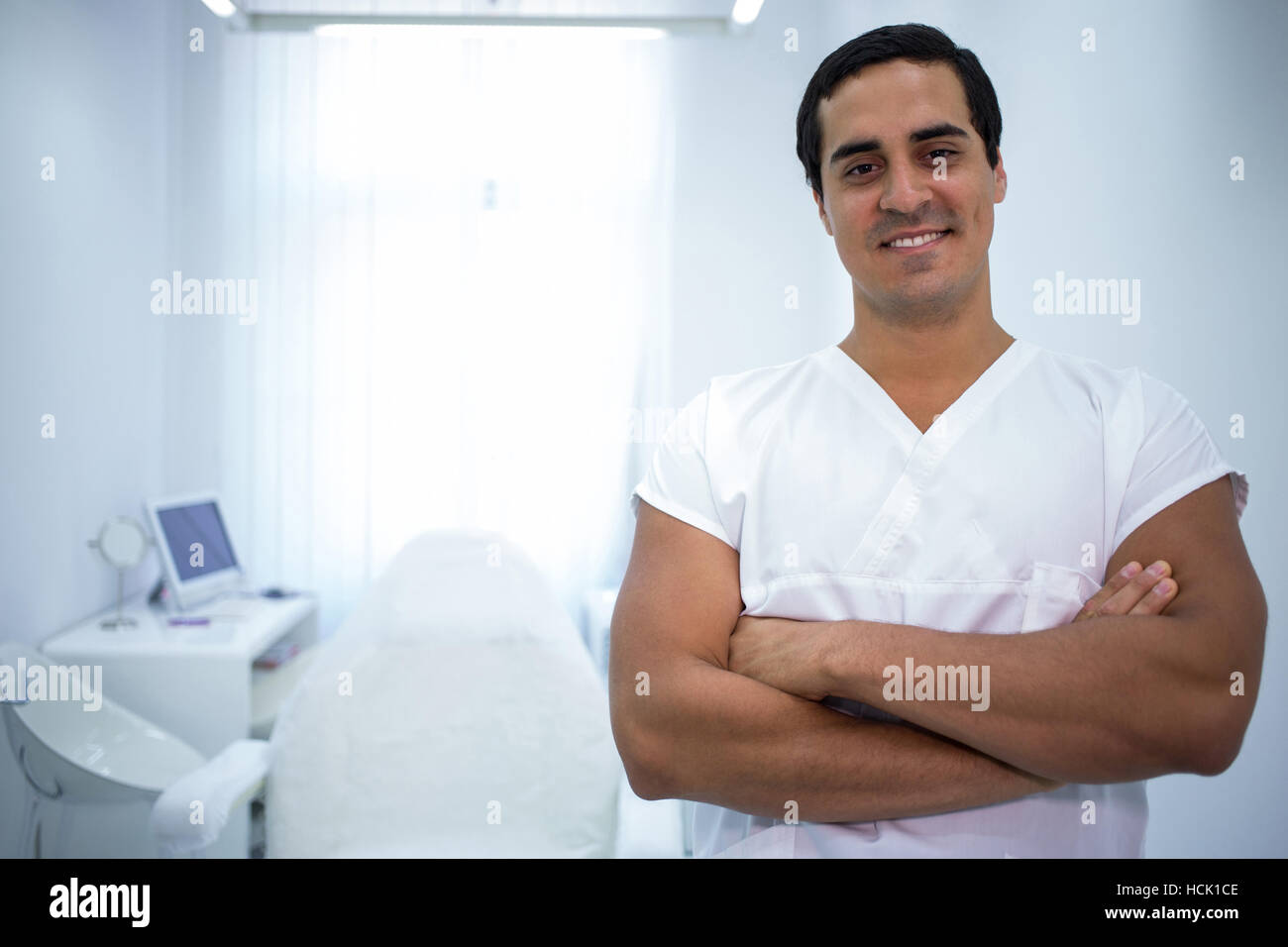 Portrait of male dentist standing with arms crossed Stock Photo - Alamy