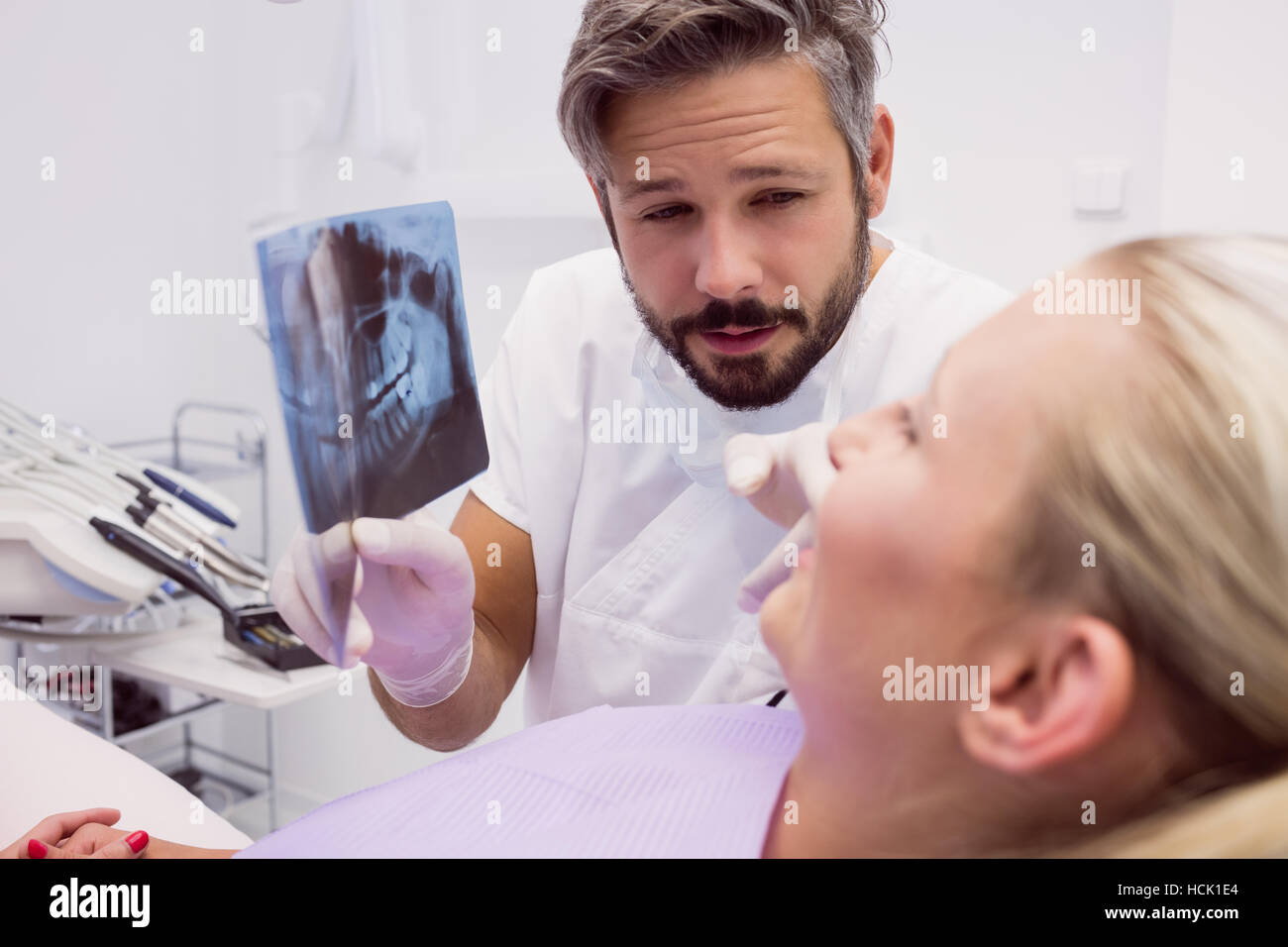 Female dentist showing x ray to patient at medical clinic hi-res stock ...