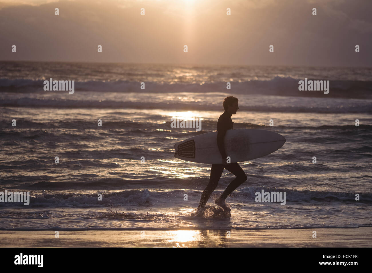 Carrying surfboard man walking on hi-res stock photography and images ...