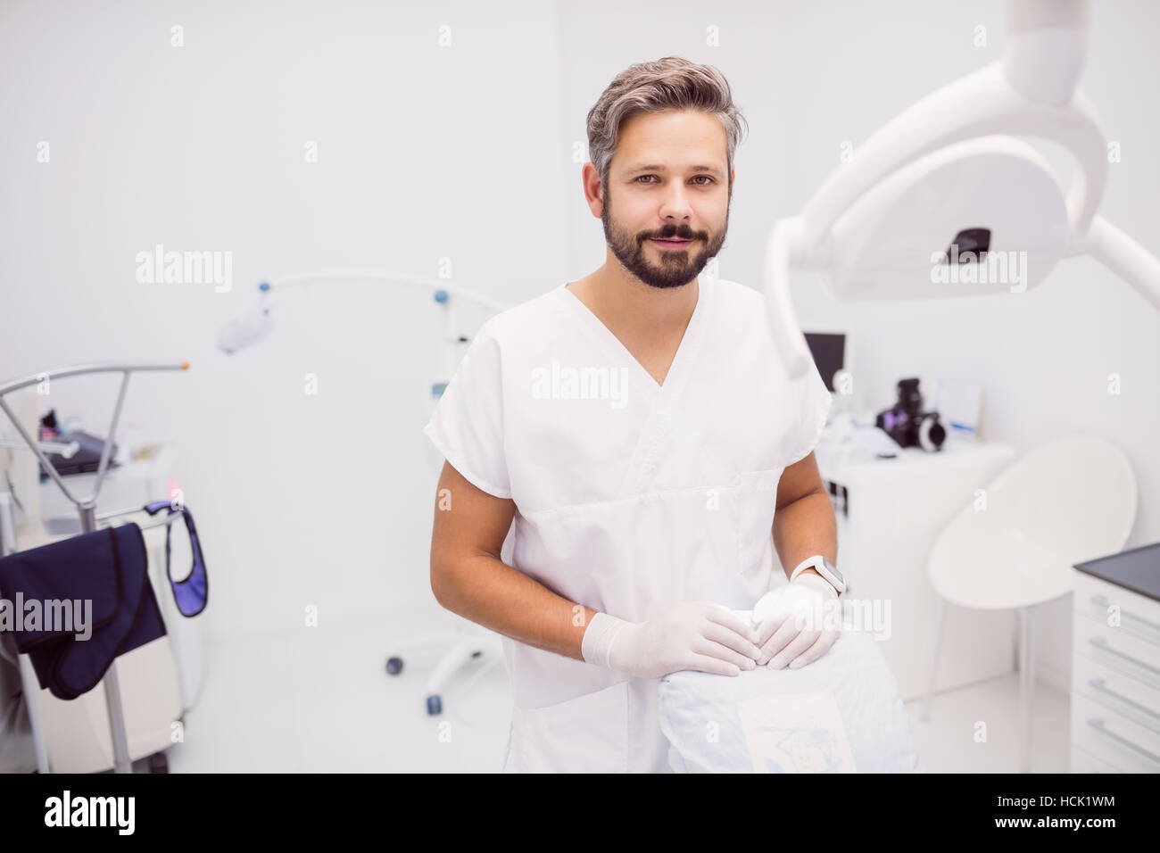 Dentist standing in clinic Stock Photo - Alamy