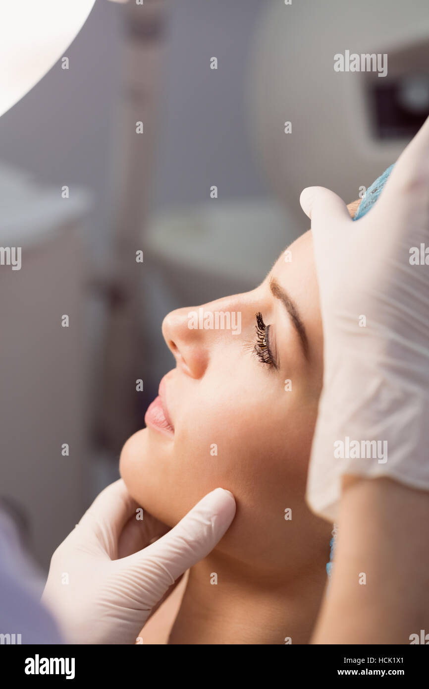 Doctor examining womans face for cosmetic treatment Stock Photo - Alamy