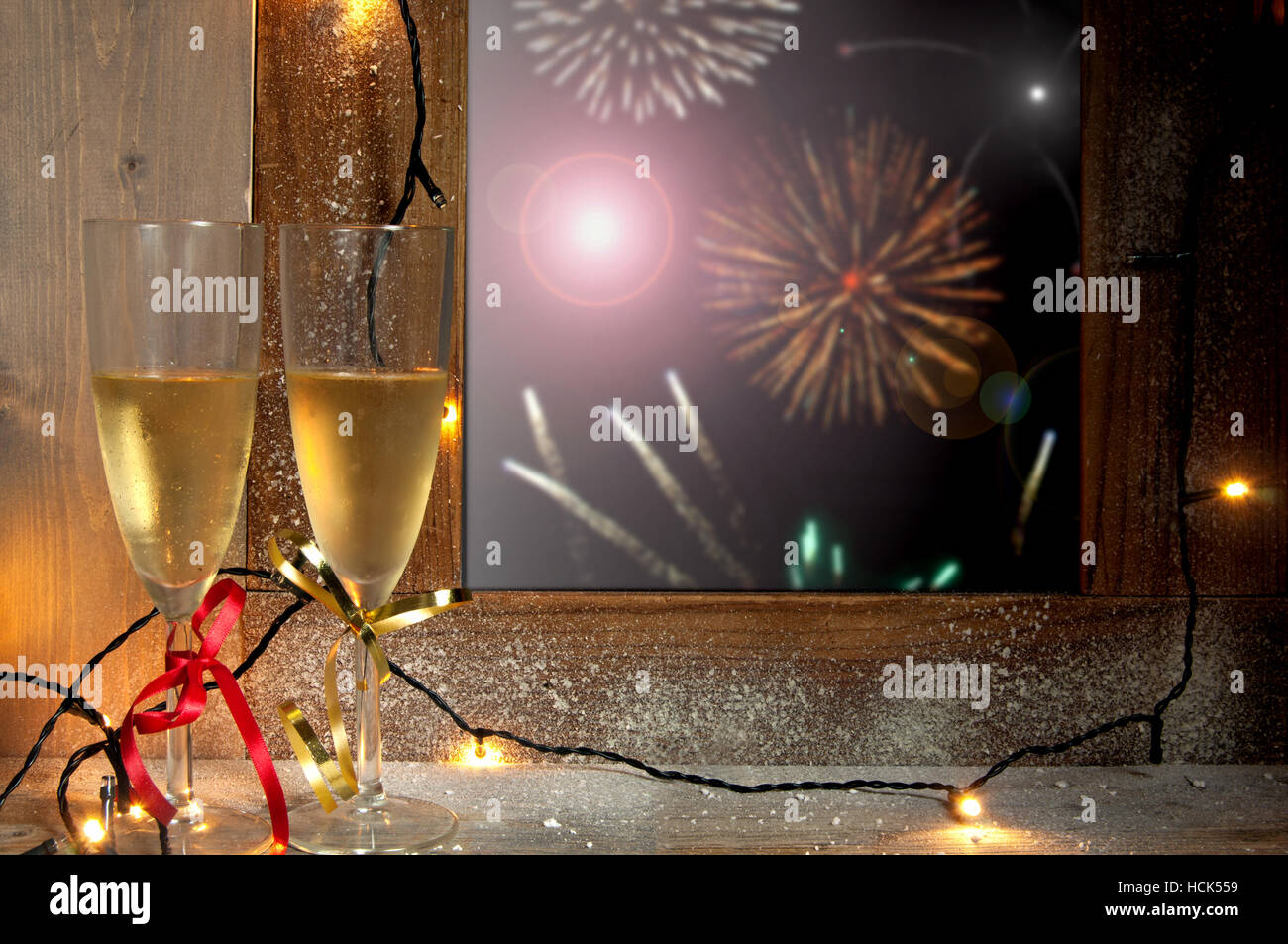 Champagne glasses next to a window with firework display Stock Photo ...