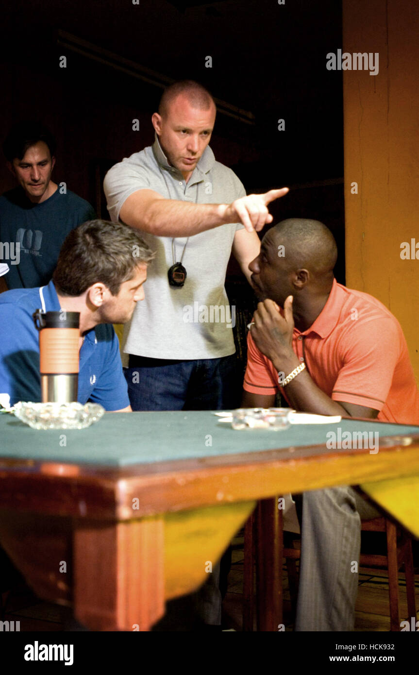 ROCKNROLLA, foreground from left: Gerard Butler, director Guy Ritchie ...