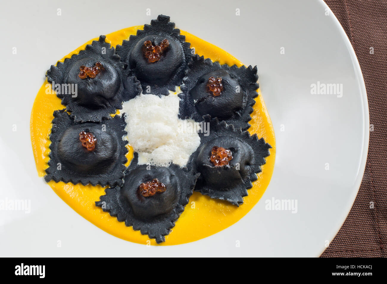 Squid ink ravioli of black color Stock Photo - Alamy