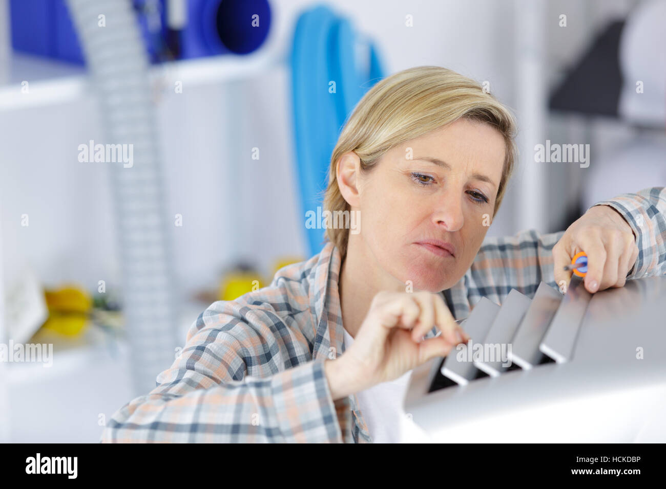 repairwoman fixing machinery at construction site Stock Photo - Alamy