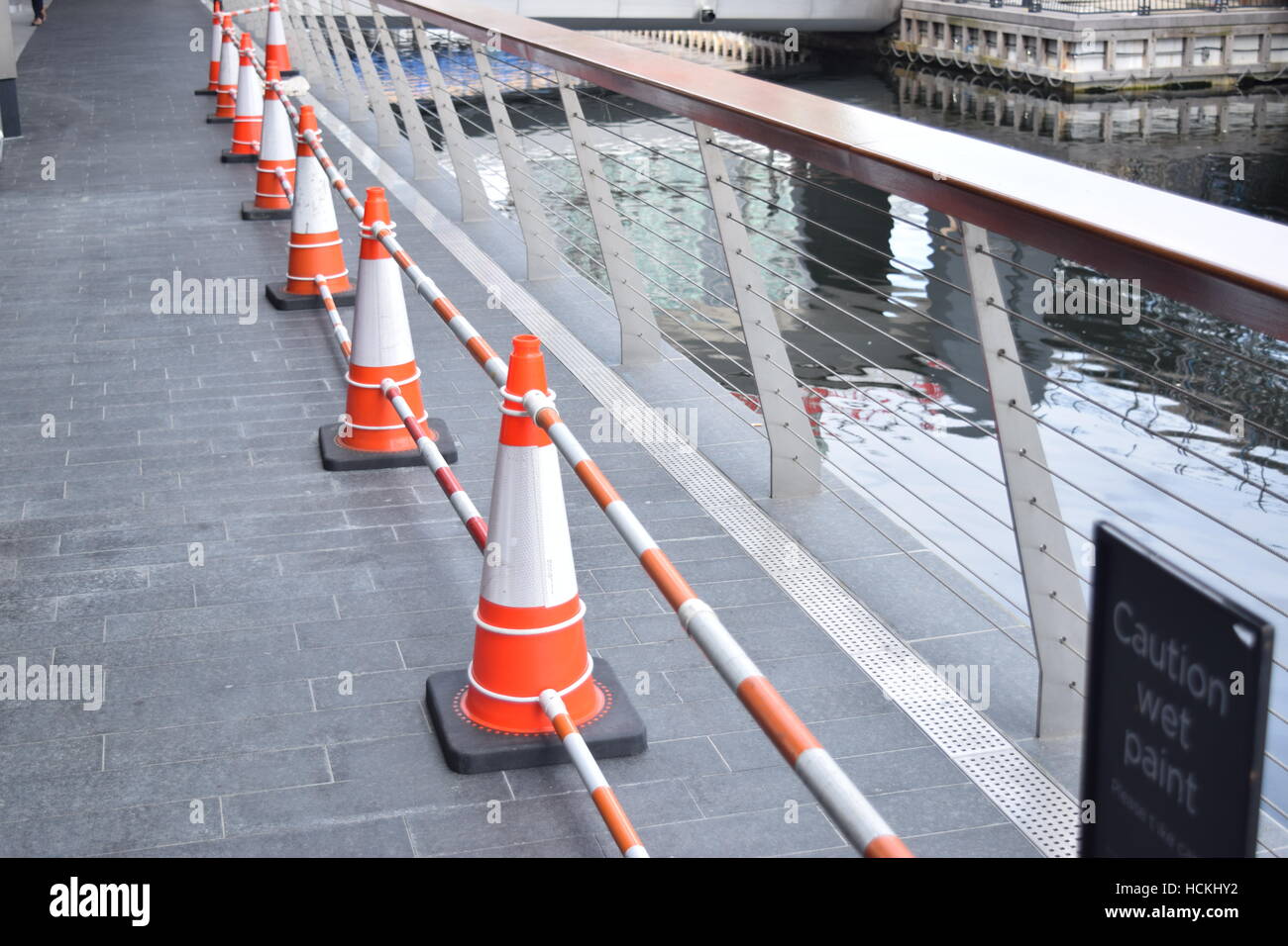 Row of traffic cones showing caution on a bridge Stock Photo - Alamy
