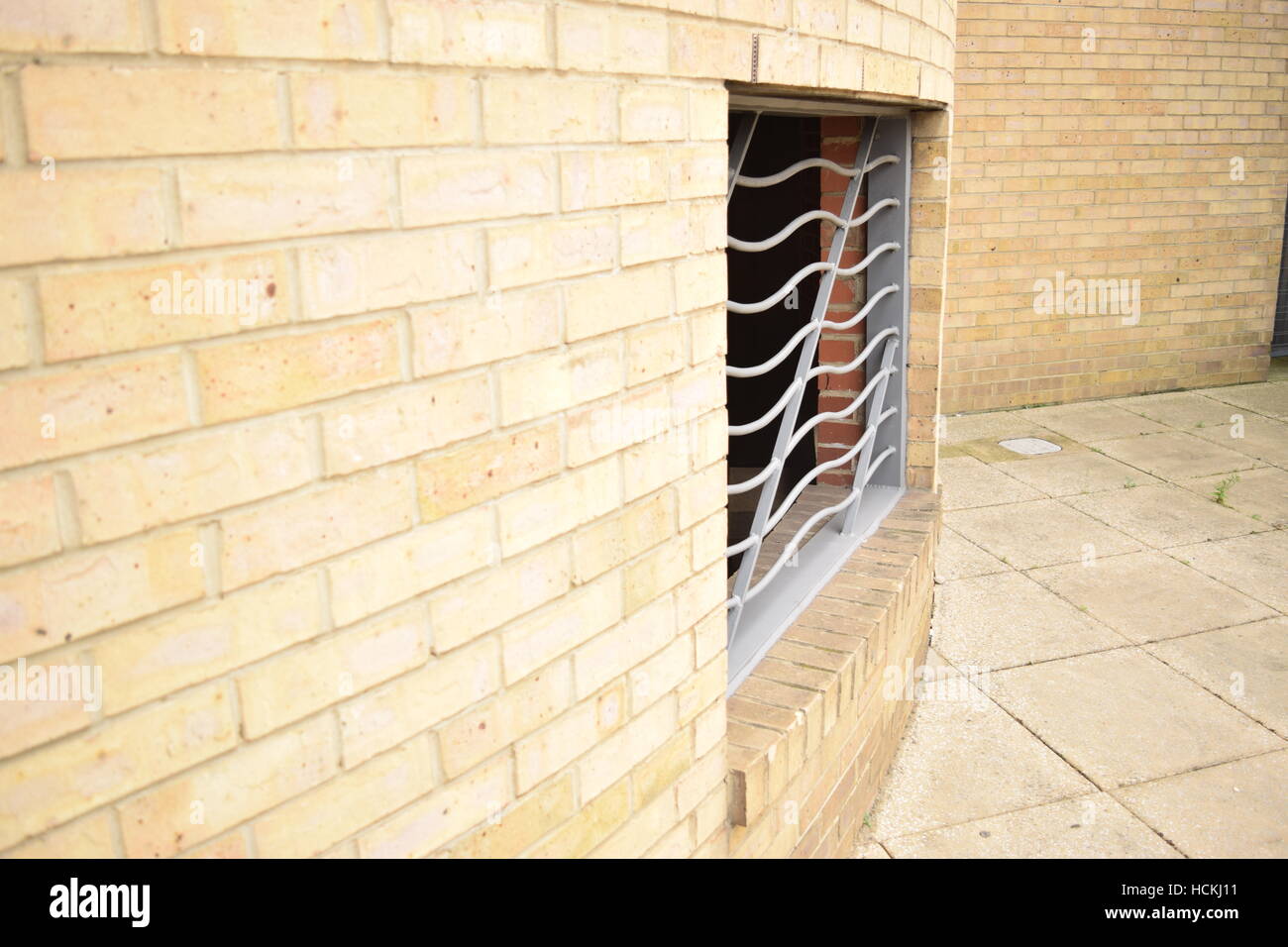 Metal bars covering window in brick wall to underground parking Stock ...