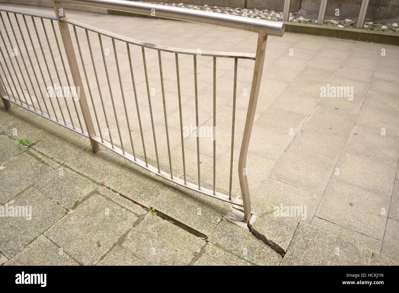Damaged modern metal railing in the business district of Canary Wharf ...