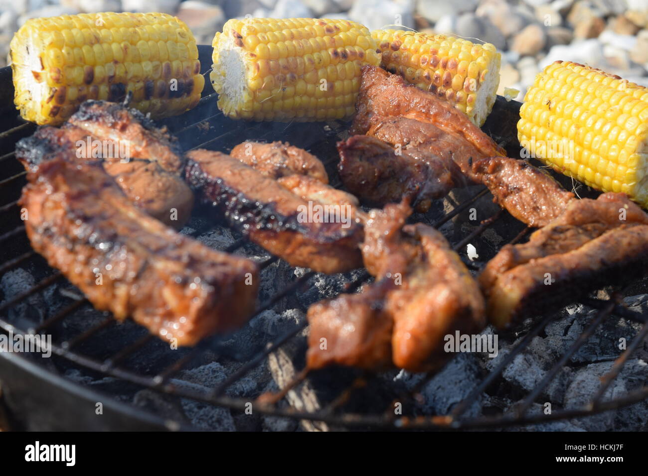 Cooked pork ribs and organic sweetcorn Stock Photo - Alamy