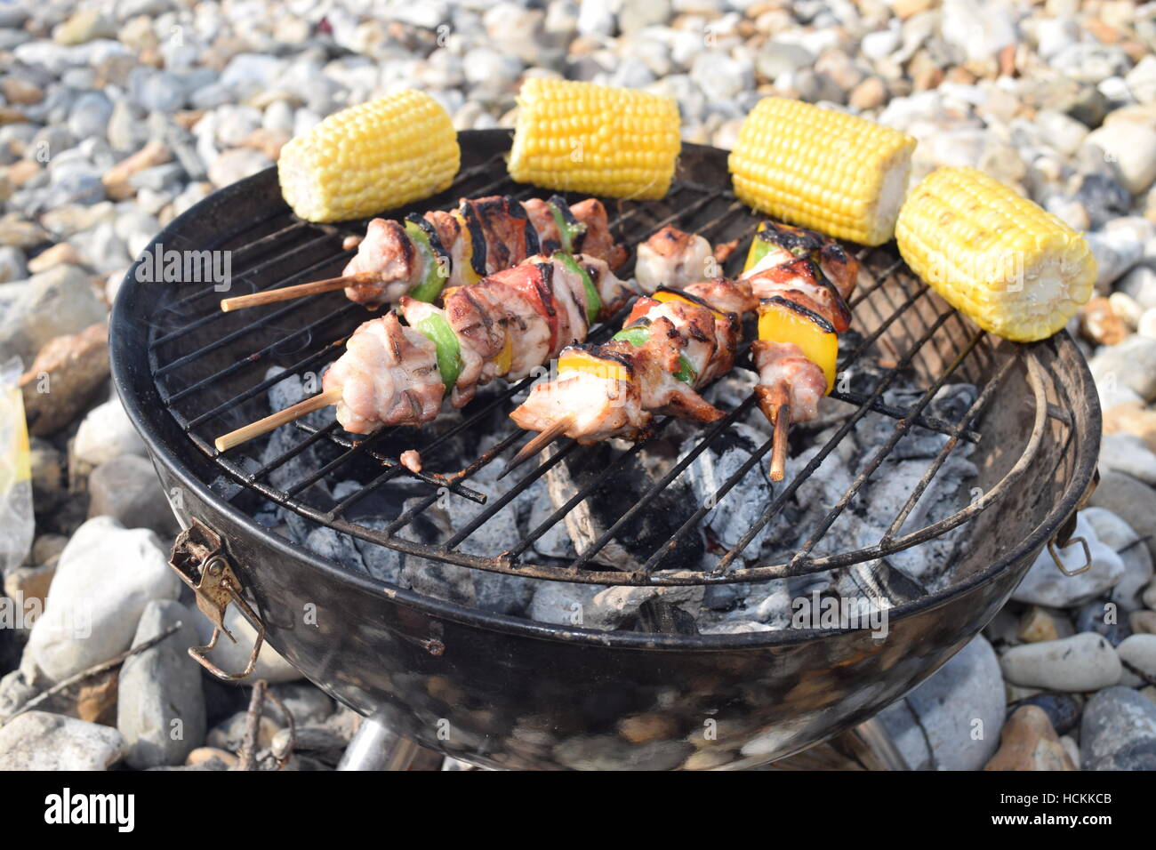 Mini meat and sweetcorn barbecue on a barbecue grill Stock Photo - Alamy