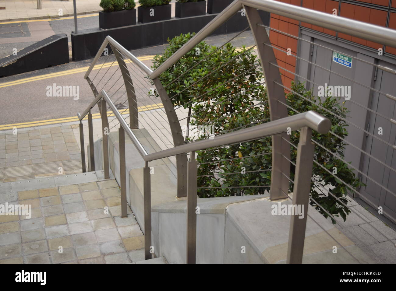 Railing downstairs on the street with bushes in the background Stock ...