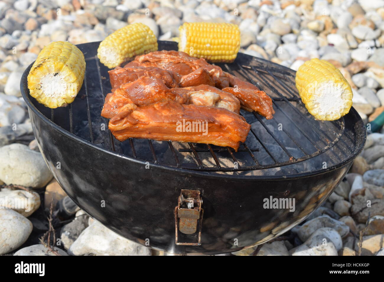 Freshly marinated ribs with sweetcorn ready to grill on the outdoor ...