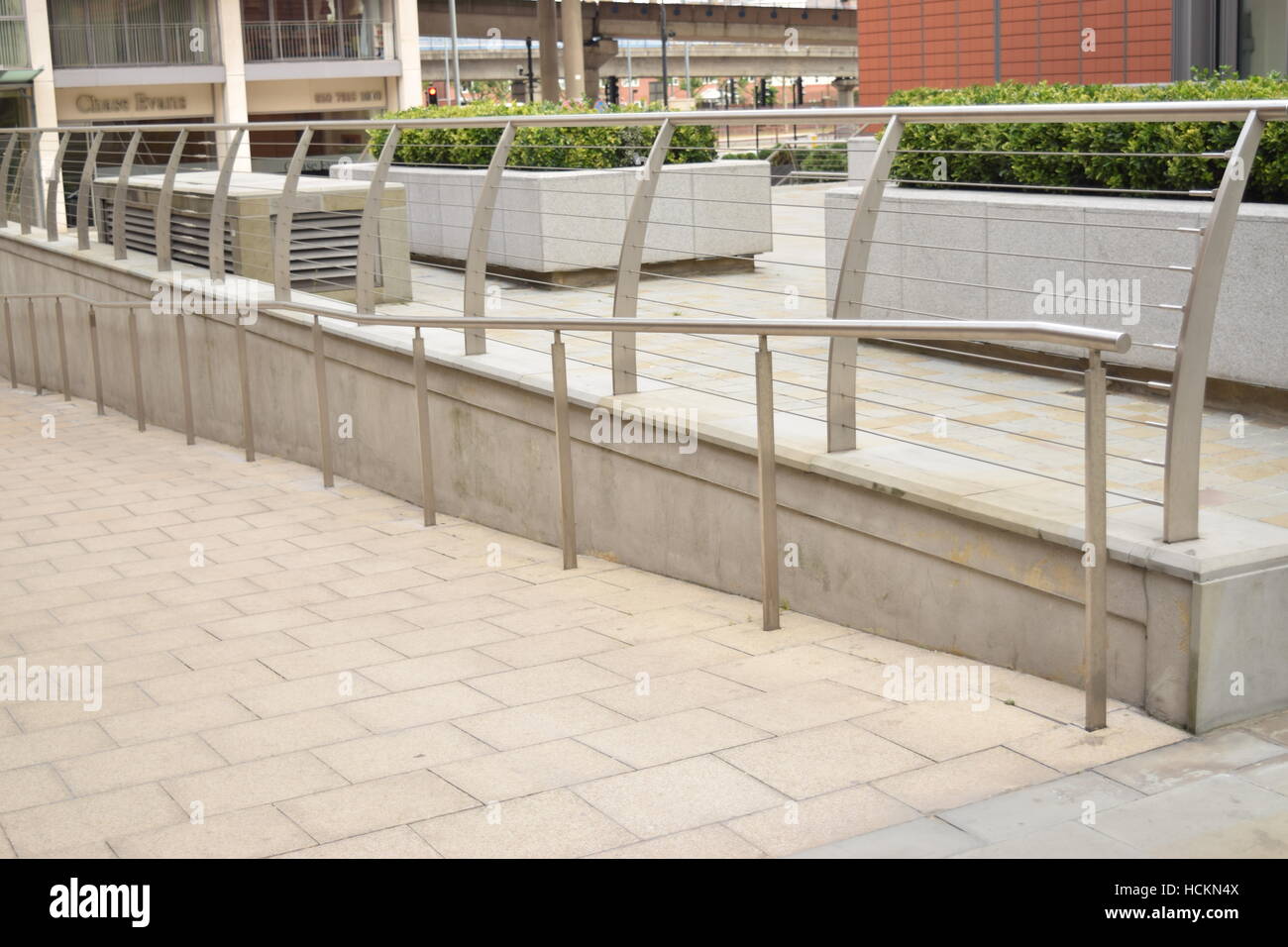 Railing on the street leading high street shops Stock Photo - Alamy