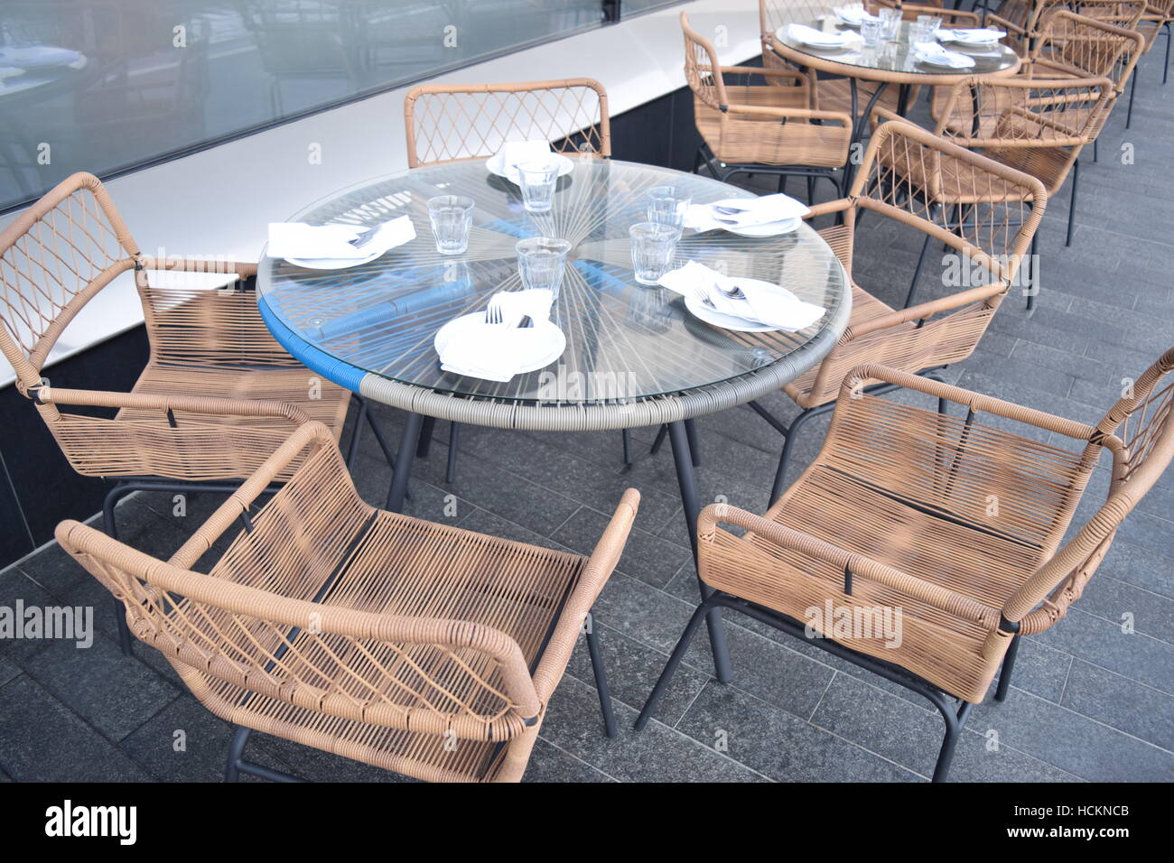 Perspective of wooden chairs around a table in an outdoor restaurant ...