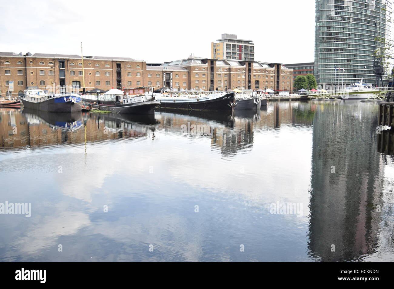 River canal scenery with huge castle in the background and boats on the ...