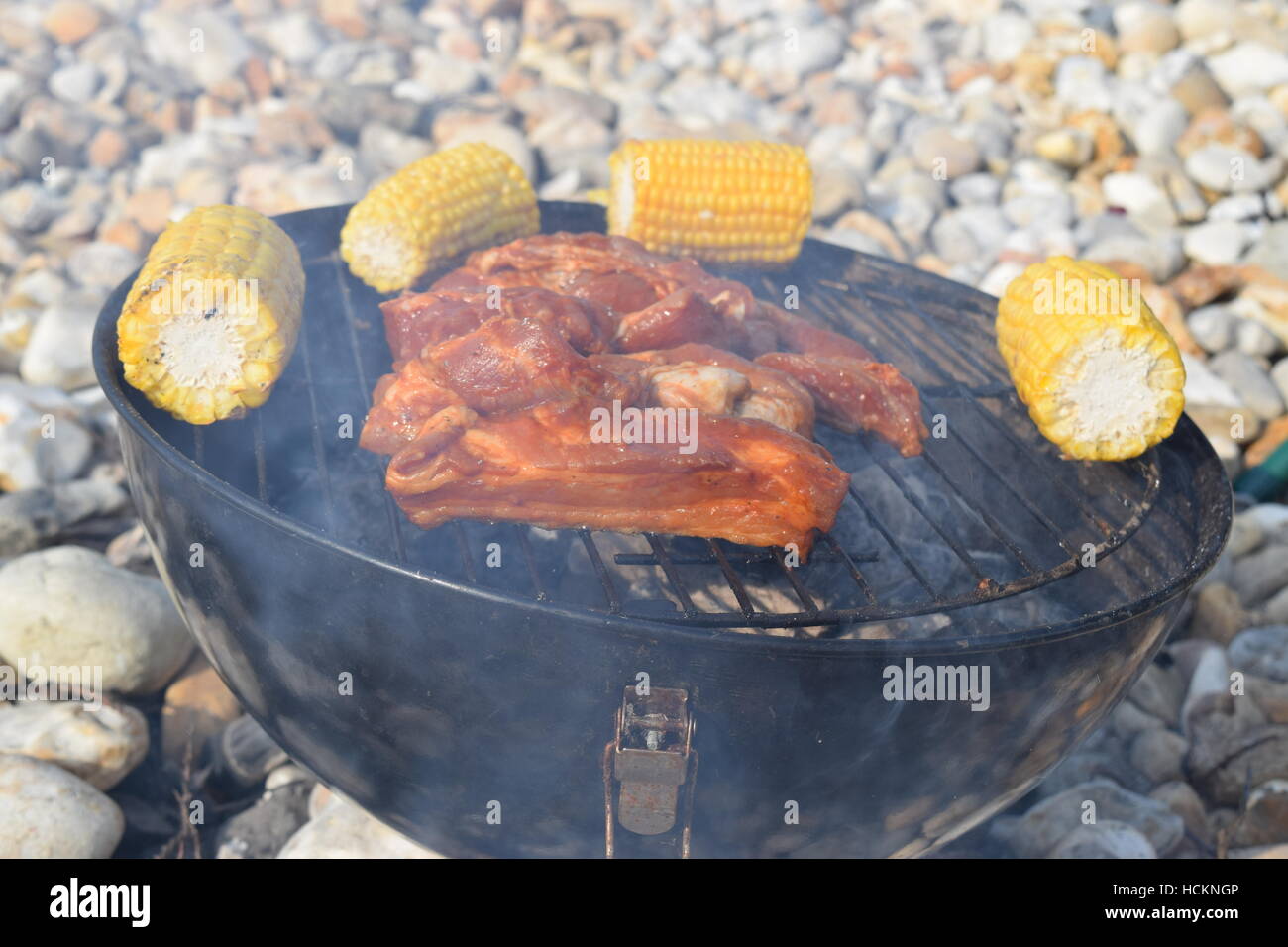 Juicy marinated ribs with sweetcorn on a barbecue Stock Photo - Alamy