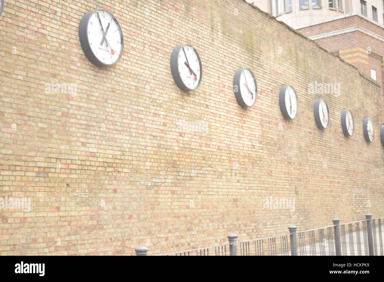 Row of clock times around the world leading to a train station Stock ...