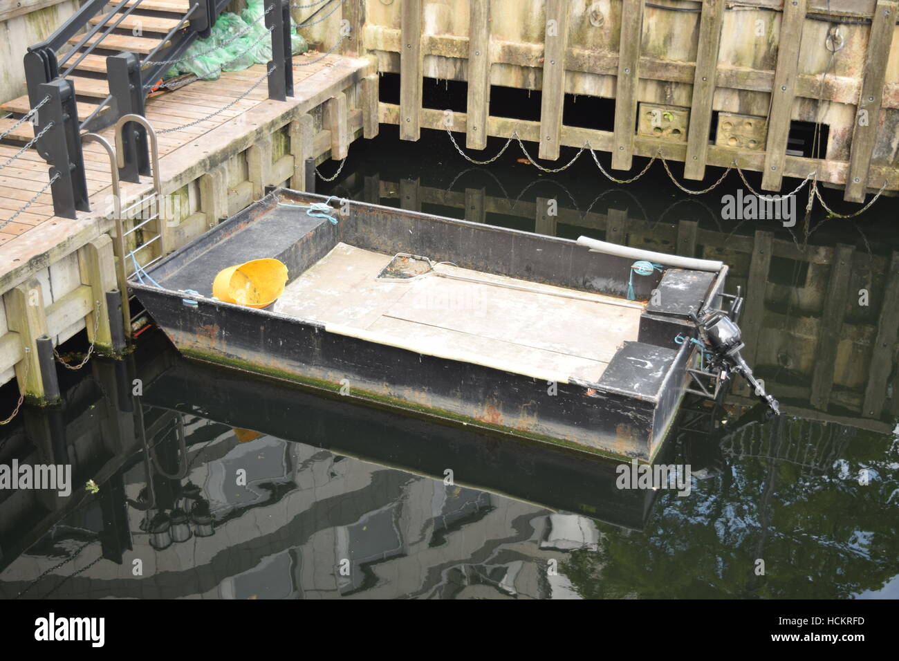 Small flat boat floating on the water surface Stock Photo - Alamy