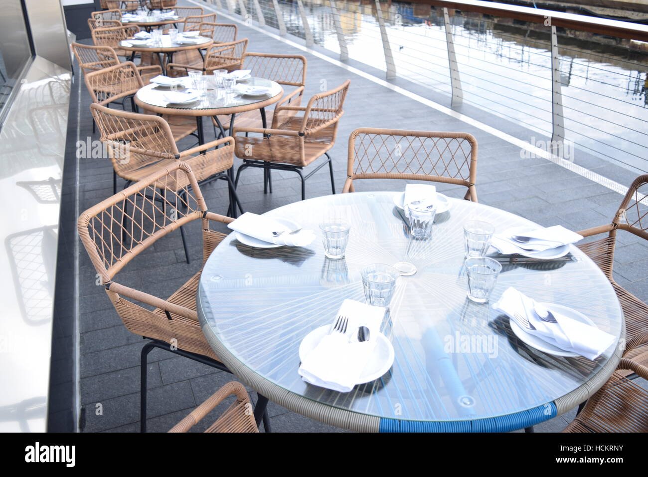 Long line of cafe tables outdoors on a bridge Stock Photo - Alamy